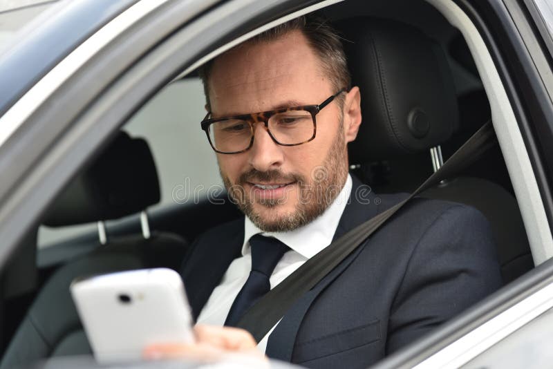 Businessman Sitting in Car and Using Smartphone Stock Image - Image of ...