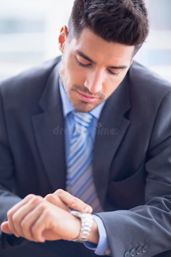 Businessman Sitting Checking His Watch Stock Image - Image of sofa ...