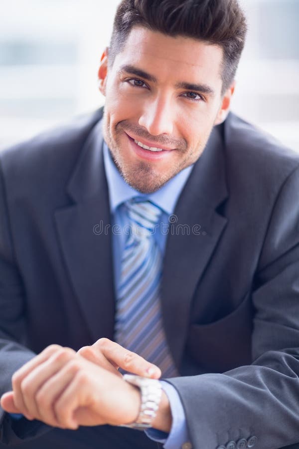 Businessman Sitting Checking His Watch Smiling at Camera Stock Image ...