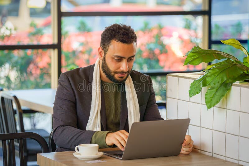 Businessman Sitting in Coffee Shop Working with Laptop Computer Stock ...