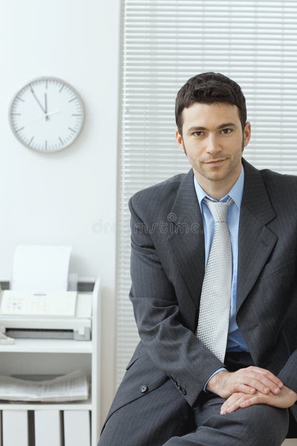 Businessman Sitting on Desk Stock Photo - Image of businesspeople ...