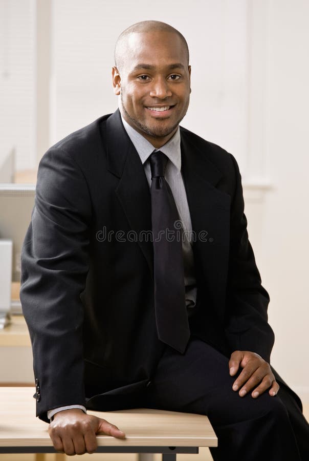 Businessman Sitting on Desk Stock Image - Image of business, sitting ...
