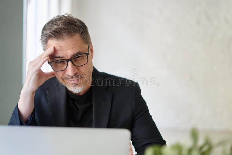 Businessman Sitting at Desk in Office Having Problem Stock Photo ...