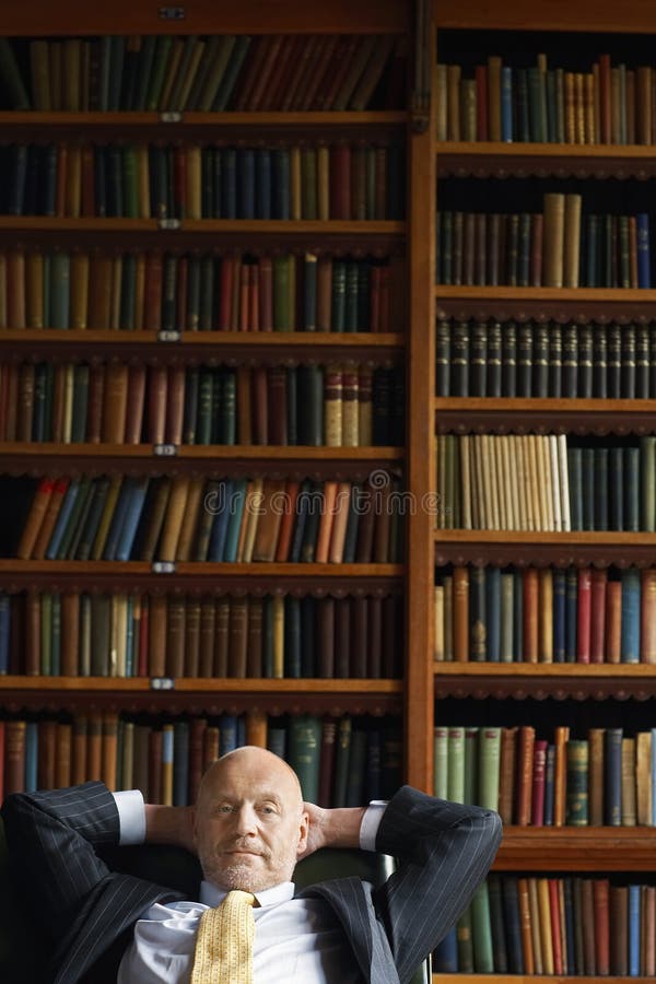 Portrait of Senior Businessman Sitting in Library Stock Image - Image ...