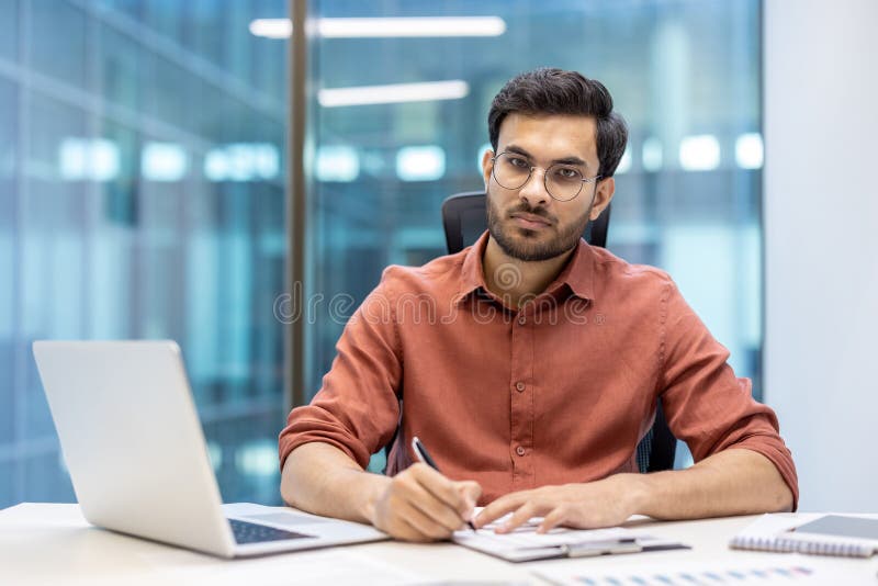 Serious Businessman Working at Office Desk with Laptop and Notebook in ...