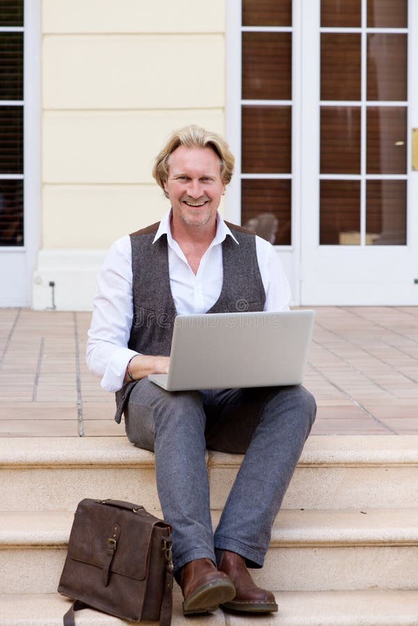 Businessman Sitting Outside on Steps with Laptop Computer Stock Photo ...
