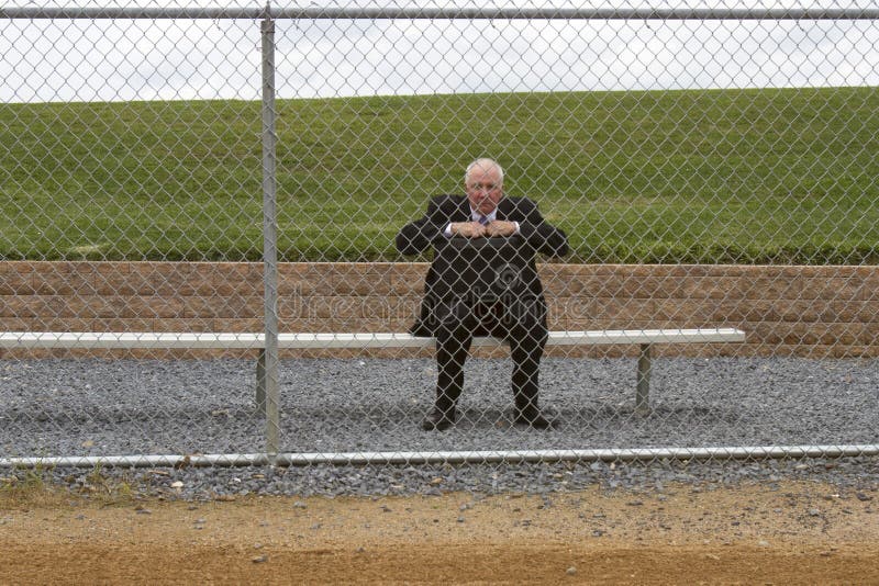 Businessman Sitting on Sidelines Stock Image - Image of ballfield ...