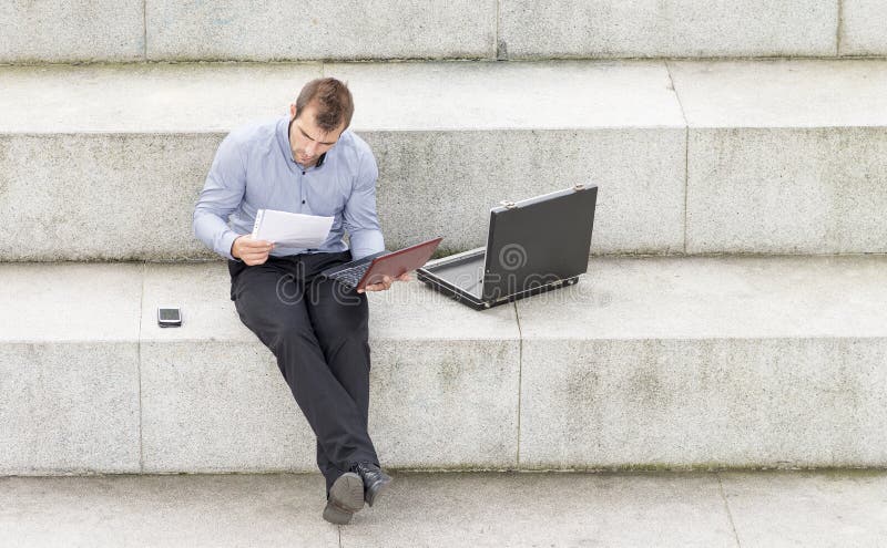 Businessman Sitting on the Steps and Working with Computer. Stock Image ...