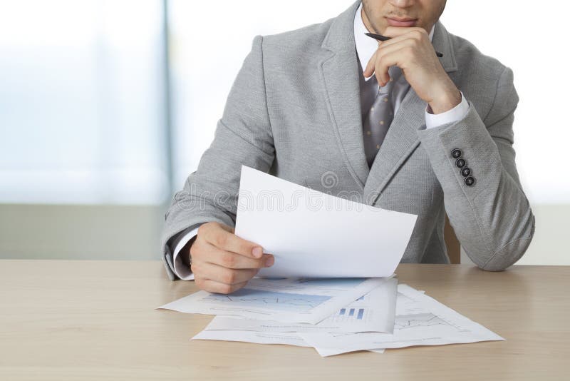 Businessman Sitting Table and Holding Document Stock Photo - Image of ...