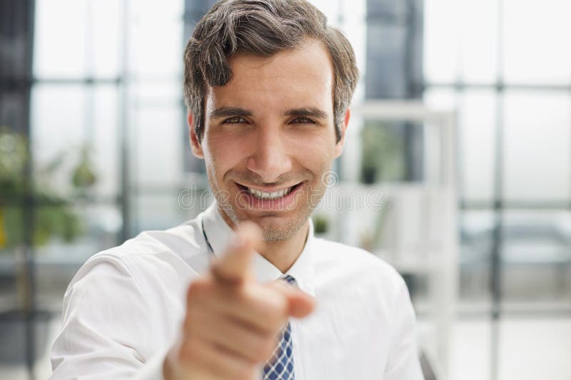 Businessman Sitting on the Table and Pointing at You Stock Image ...