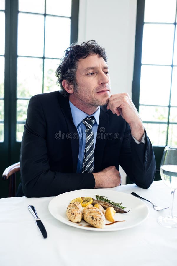 Businessman Sitting at Table Stock Photo - Image of mature, dressed ...
