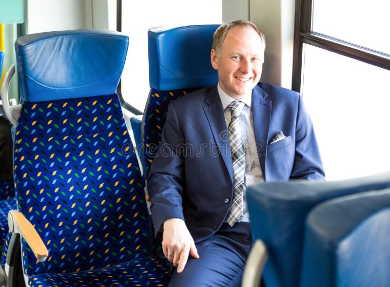 Businessman Sitting in a Train Stock Image - Image of smile, railway ...
