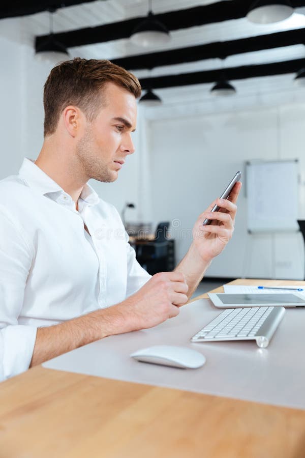 Businessman Sitting at Workplace and Using Cell Phone Stock Image ...