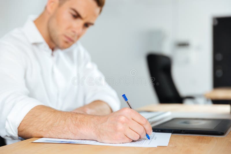 Businessman Sitting and Writing at the Table Stock Image - Image of ...