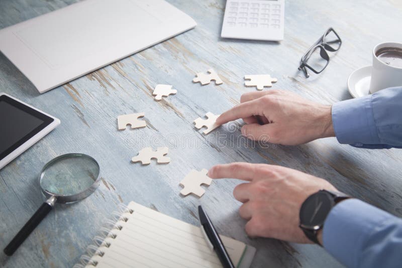 Businessman Solving Puzzle at the Office Desk Stock Photo - Image of ...