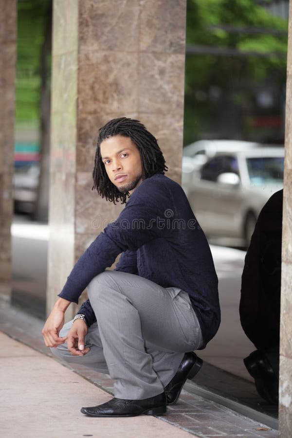 Man in a squatting pose stock photo. Image of selective - 35217364