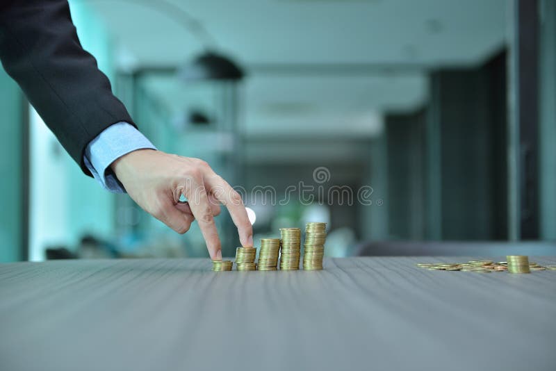 Businessman Stacking Coins in Increasing Order at Desk Stock Photo ...