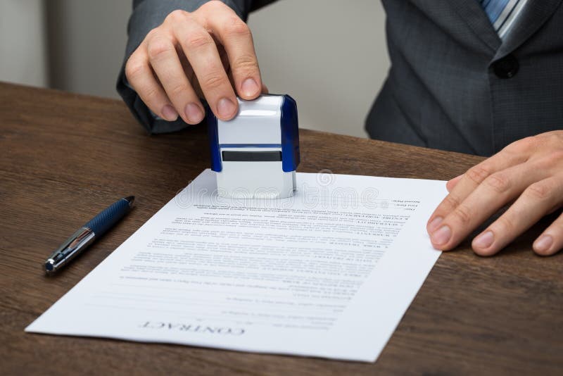 Businessperson Stamping Document in Office Stock Image - Image of ...