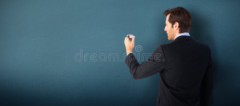 Composite Image of Businessman Standing Back To Camera Writing with ...