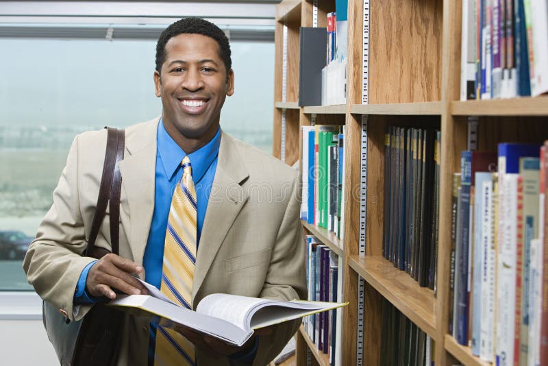 Businessman Standing by Bookshelf Stock Image - Image of library, shelf ...