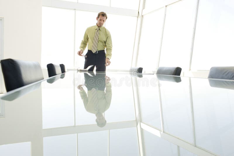 Businessman Standing at Conference Table Stock Image - Image of ...