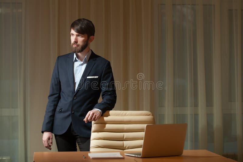 Businessman Standing at Desktop Stock Image - Image of laptop, evening ...