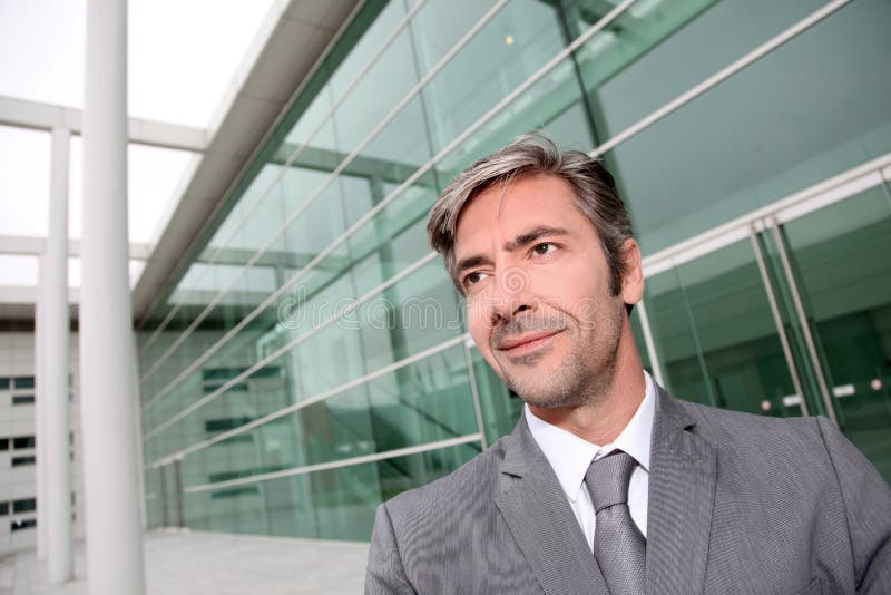 Businessman Standing in Front of the Building Stock Image - Image of ...