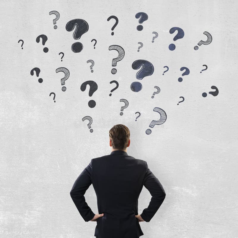 Businessman Standing with Hands on Hips Facing a Wall of Scattered ...