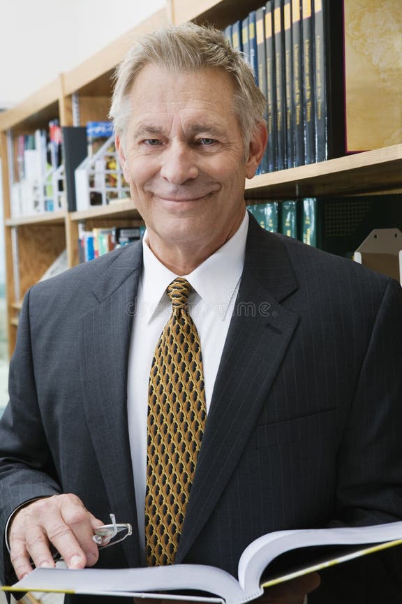 Businessman Standing in Library with Book Stock Photo - Image of ...