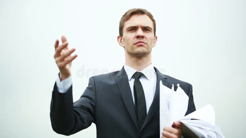 Businessman Standing with a Stack of Paper in the Wind. Throwing ...