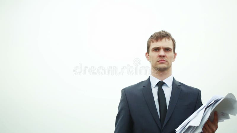 Businessman Standing with a Stack of Paper in the Wind. Throwing ...