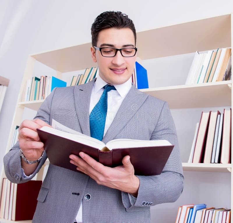 The Businessman Student Reading a Book Studying in Library Stock Photo ...