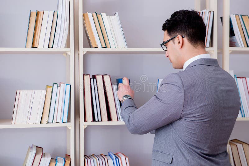 The Businessman Student Reading a Book Studying in Library Stock Photo ...