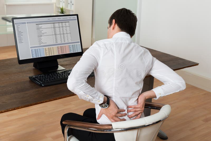 Businessman Suffering from Backache at Desk Stock Image - Image of ...
