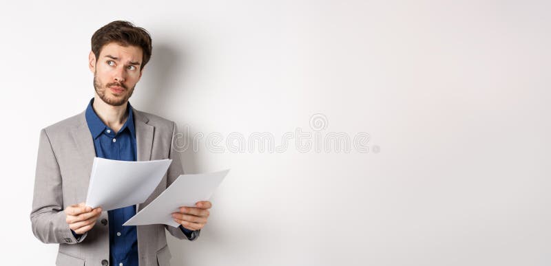 Businessman in Suit Looking through Papers, Reading Documents at Work ...