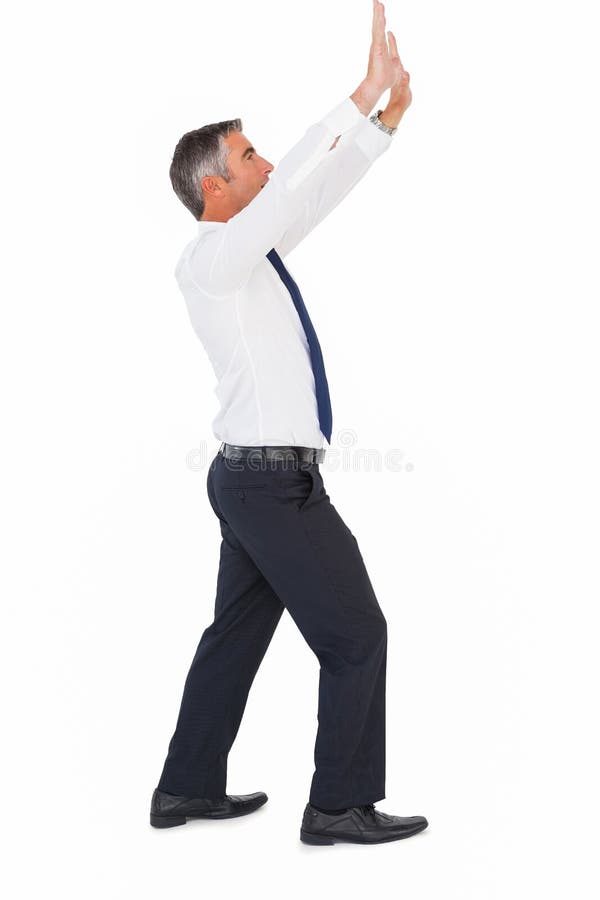 Young Business Man Pushing Something Up Stock Photo - Image of concept ...
