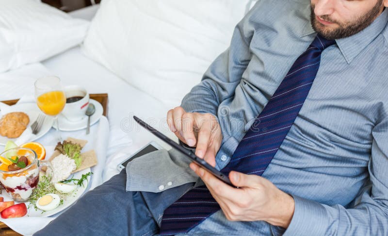 Businessman with Tablet Computer during Breakfast. he is Lying O Stock ...