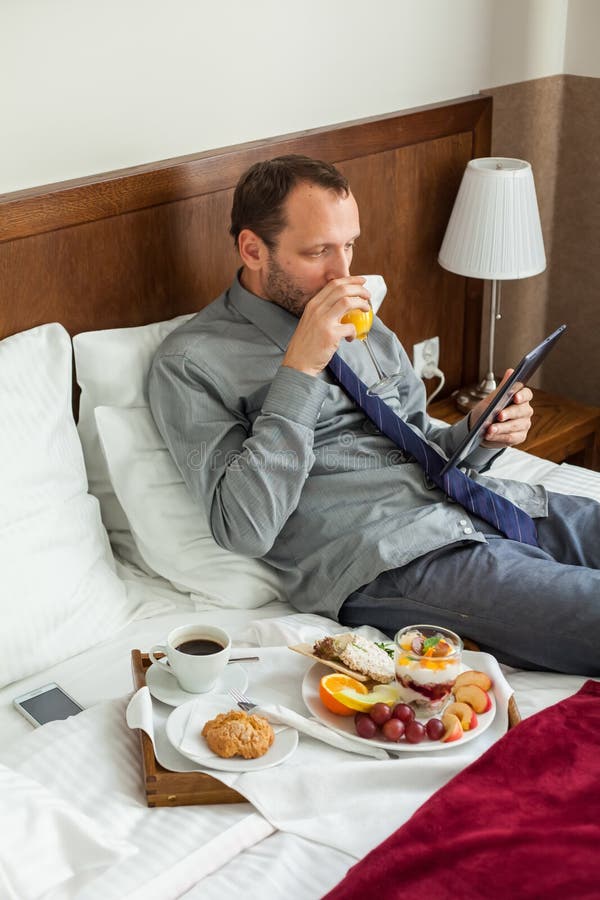 Businessman with Tablet Computer during Breakfast. he is Lying O Stock ...