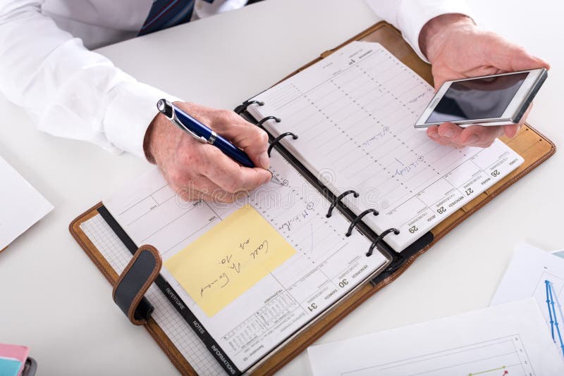 Businessman Taking an Appointment Stock Photo - Image of work, holding ...