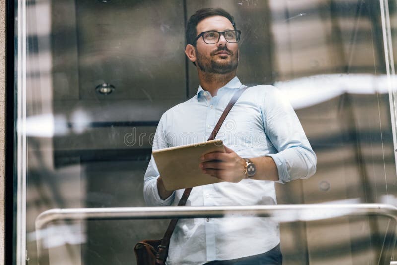 Businessman Taking the Elevator Stock Image - Image of businessperson ...