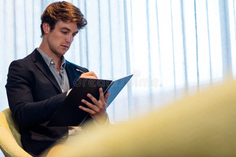 Businessman Taking Notes on a Book Stock Image - Image of concentrating ...