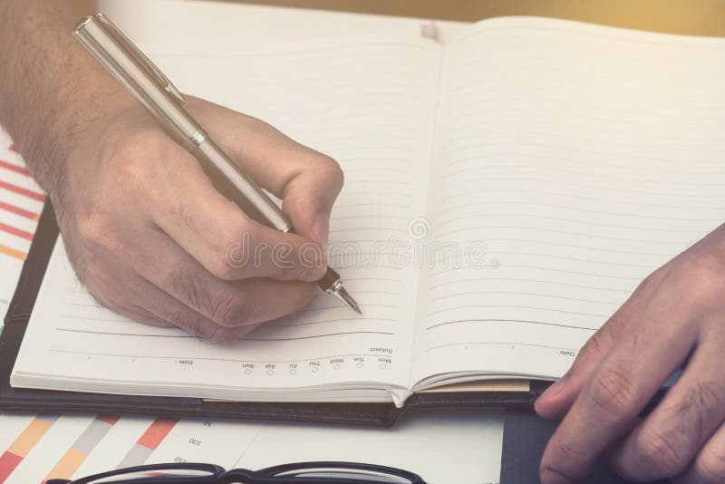 Data Analysis with Calculator from Charts on Desk at Office. Business ...