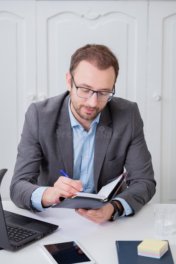 Businessman Taking Notes at His Desk Stock Photo - Image of desk ...