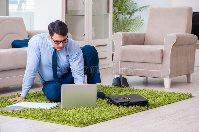 The Businessman Taking Work Home and Working Overtime Stock Photo ...