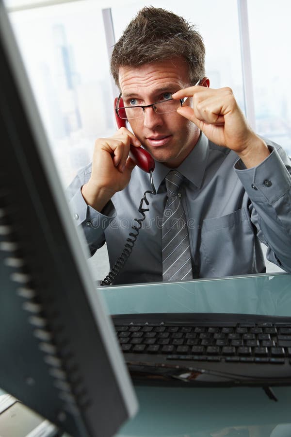 Businessman Talking on Landline Phone in Office Stock Photo - Image of ...