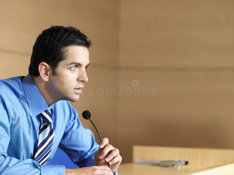 Businessman Talking into Microphone Stock Photo - Image of room, person ...