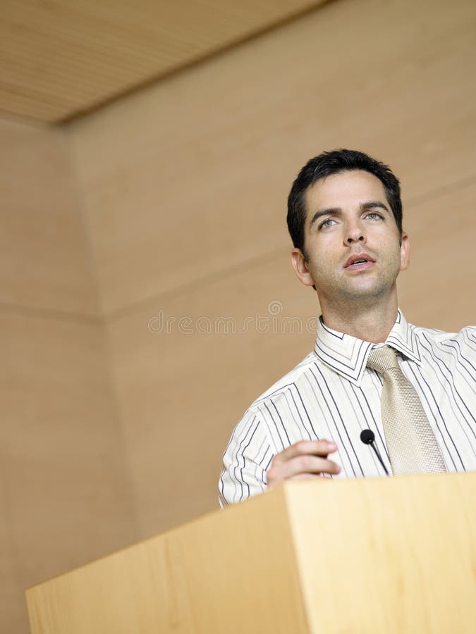Businessman Talking into Microphone Stock Photo - Image of room, person ...