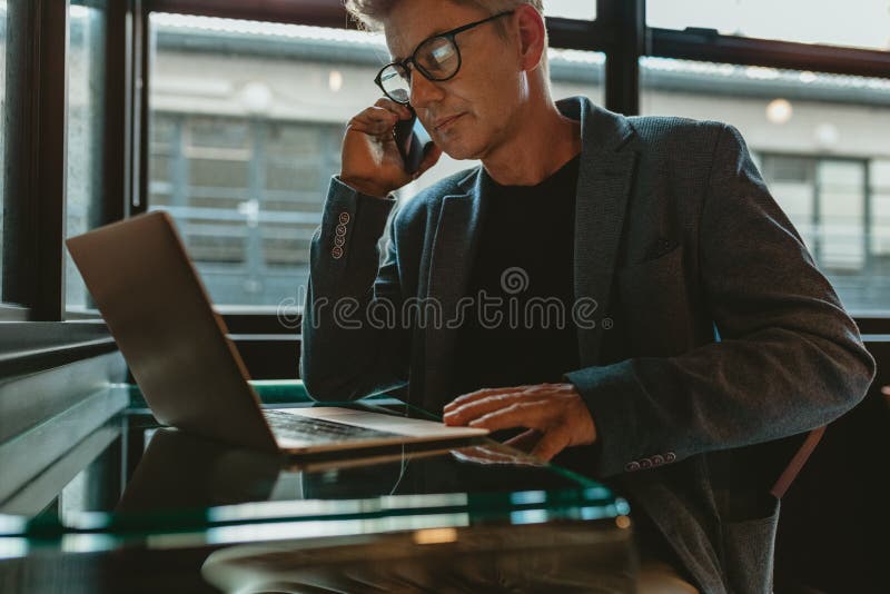 Businessman Talking Over Mobile Phone at Work Stock Photo - Image of ...