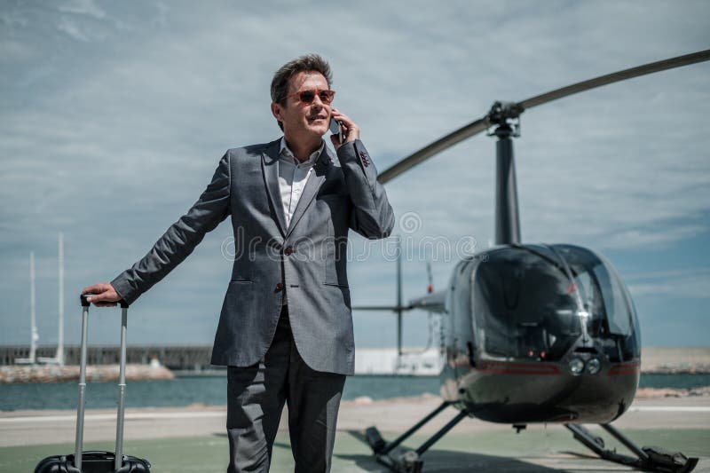 Businessman Talking Over the Phone Near Private Helicopter Stock Photo ...