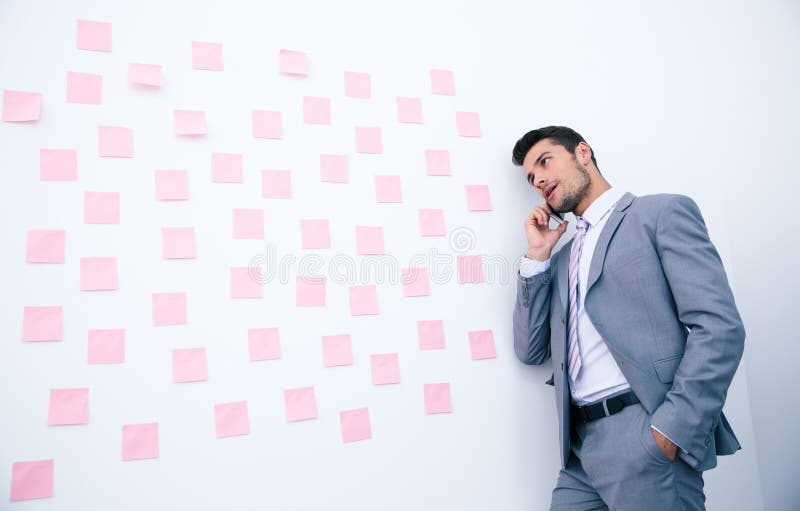 Businessman Talking on the Phone and Looking on Stickers Stock Photo ...